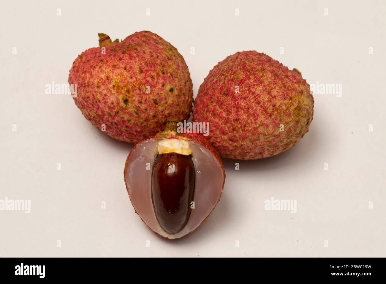 Close-up view of ripe lychee on white background Stock Photo - Alamy