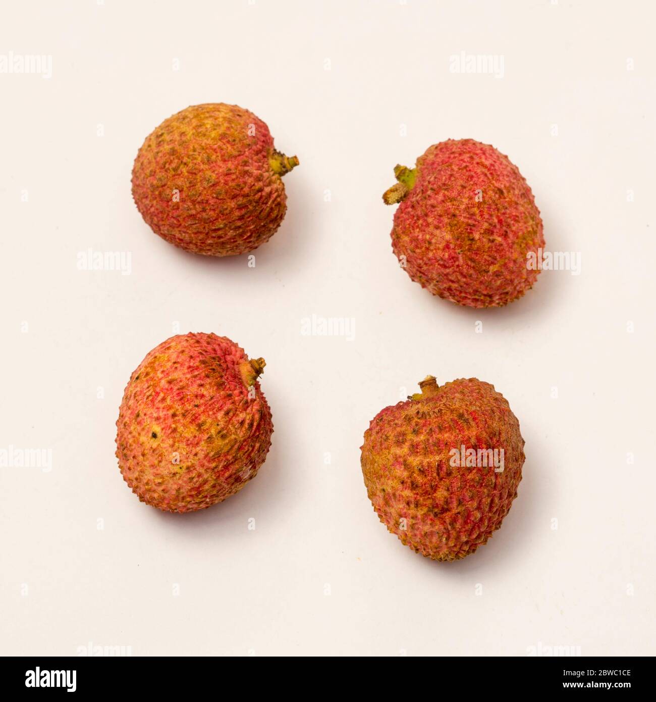 Close-up view of ripe lychee on white background Stock Photo - Alamy
