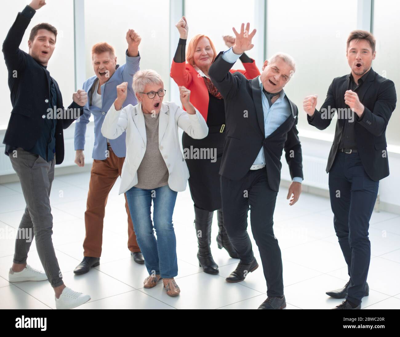 Group of joyful excited business people having fun in office Stock ...