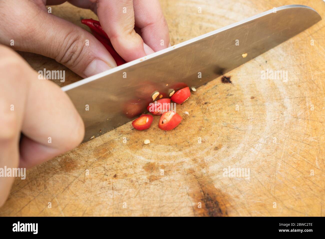 Sliced red peppers on a wood chopping board Stock Photo - Alamy