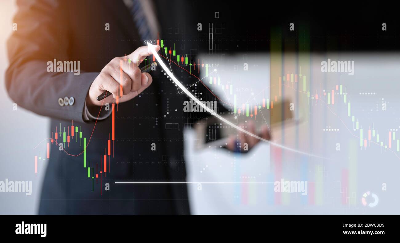 business man standing and holding smart device with stock chart ...
