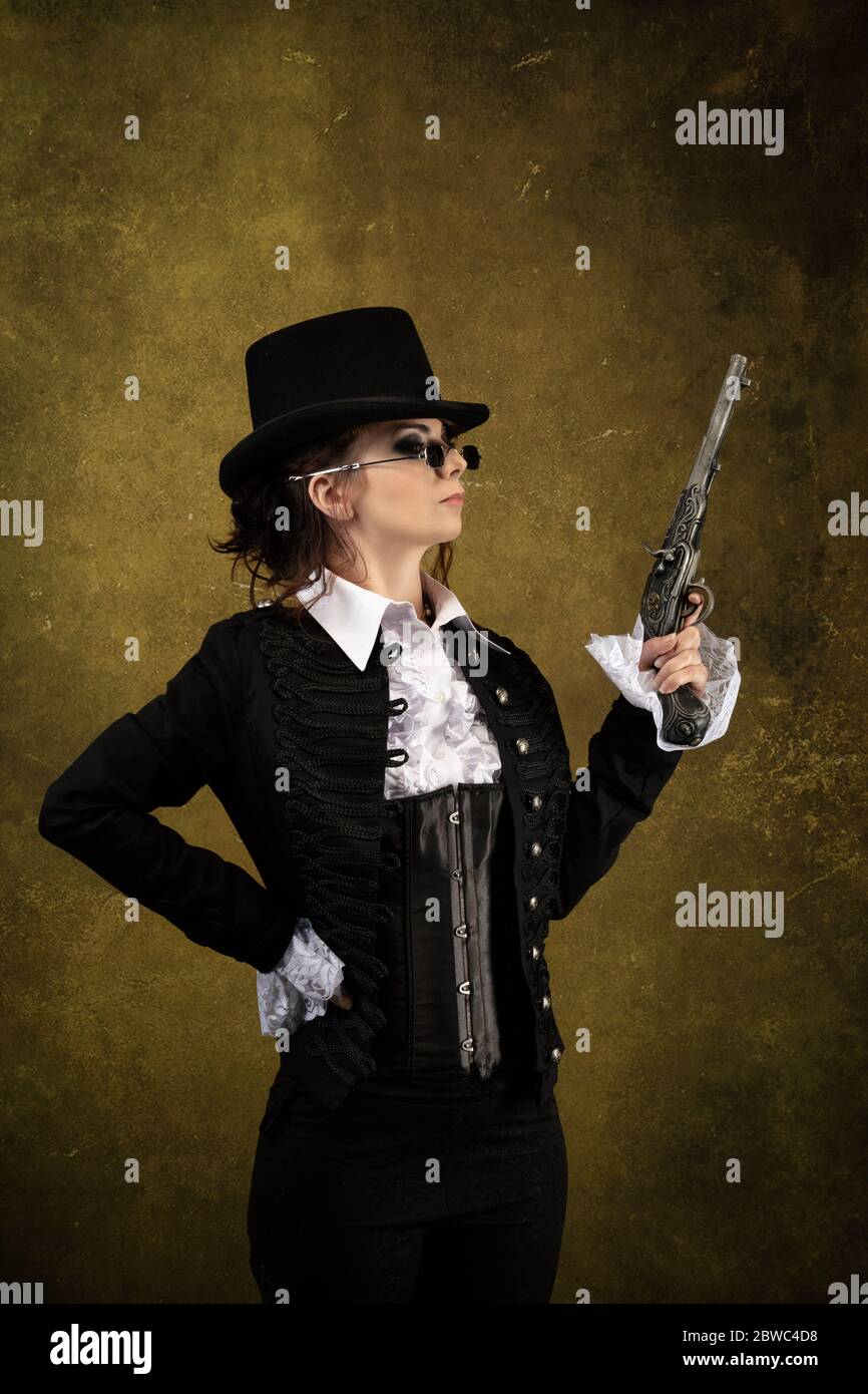 Portrait of a young Victorian woman wearing a top hat, black glasses ...