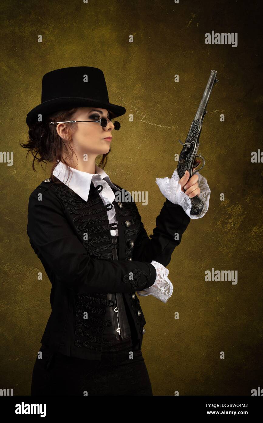 Portrait of a young Victorian woman wearing a top hat, black glasses ...