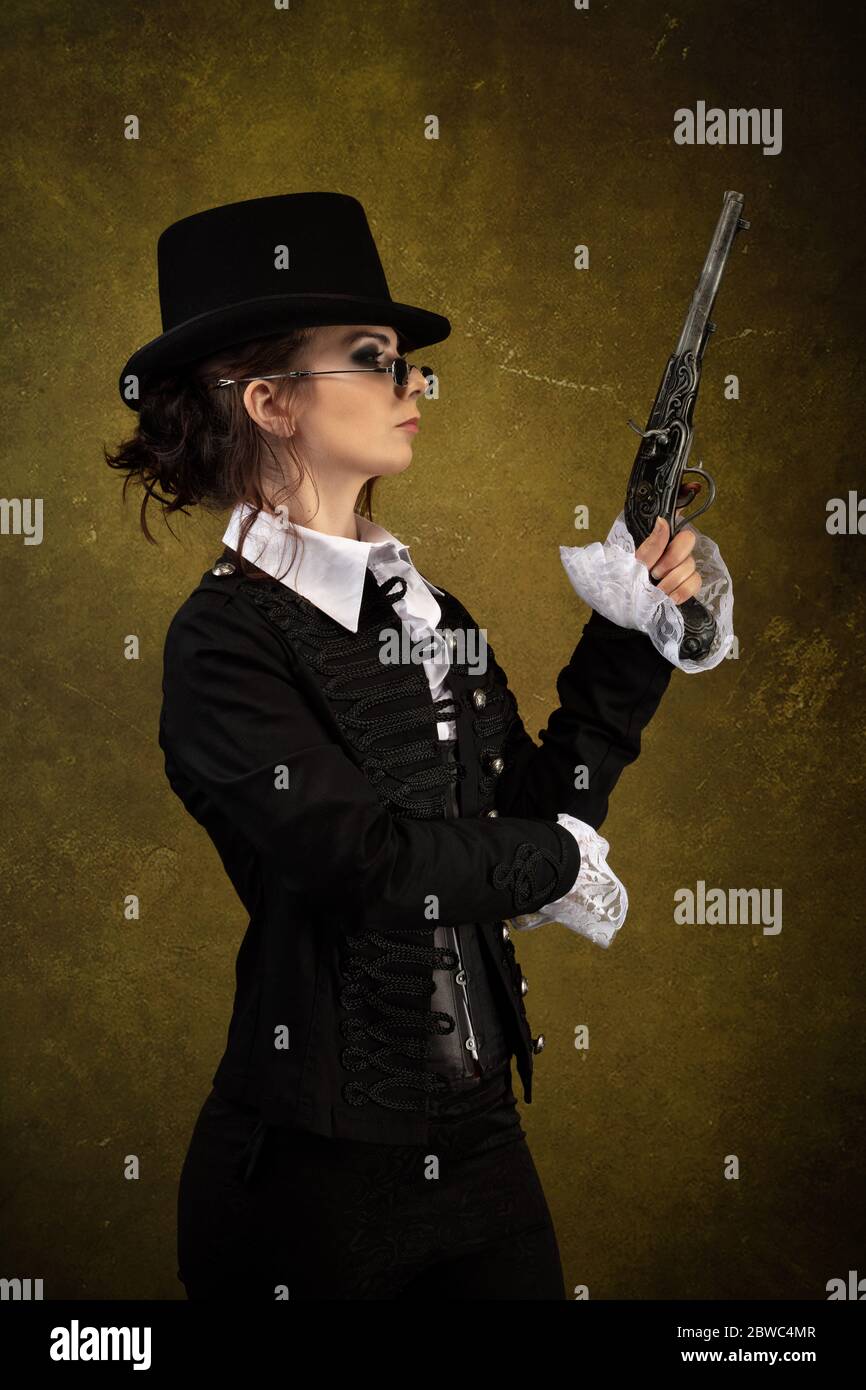 Portrait of a young Victorian woman wearing a top hat, black glasses ...