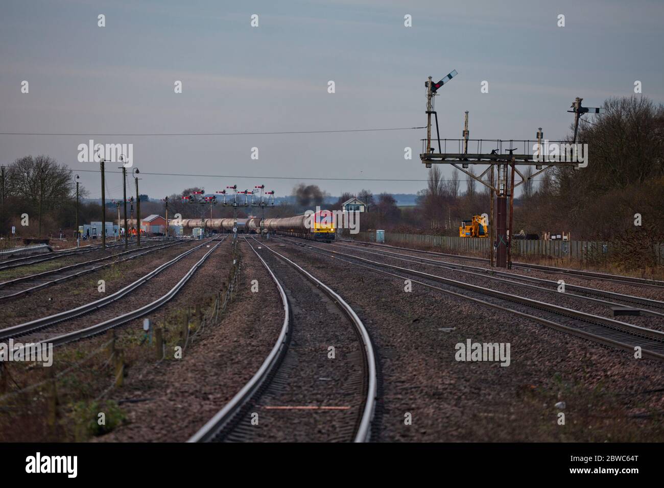 DB Cargo class 60 diesel locomotive hauling a long freight train of oil ...