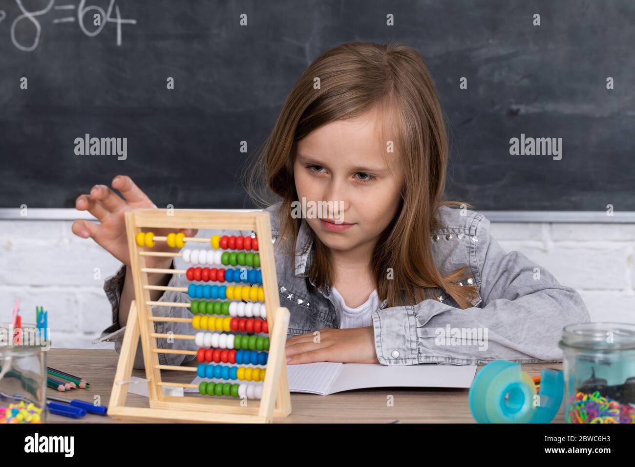 Abacus for adding different numbers. The girl at a math lesson adds on ...