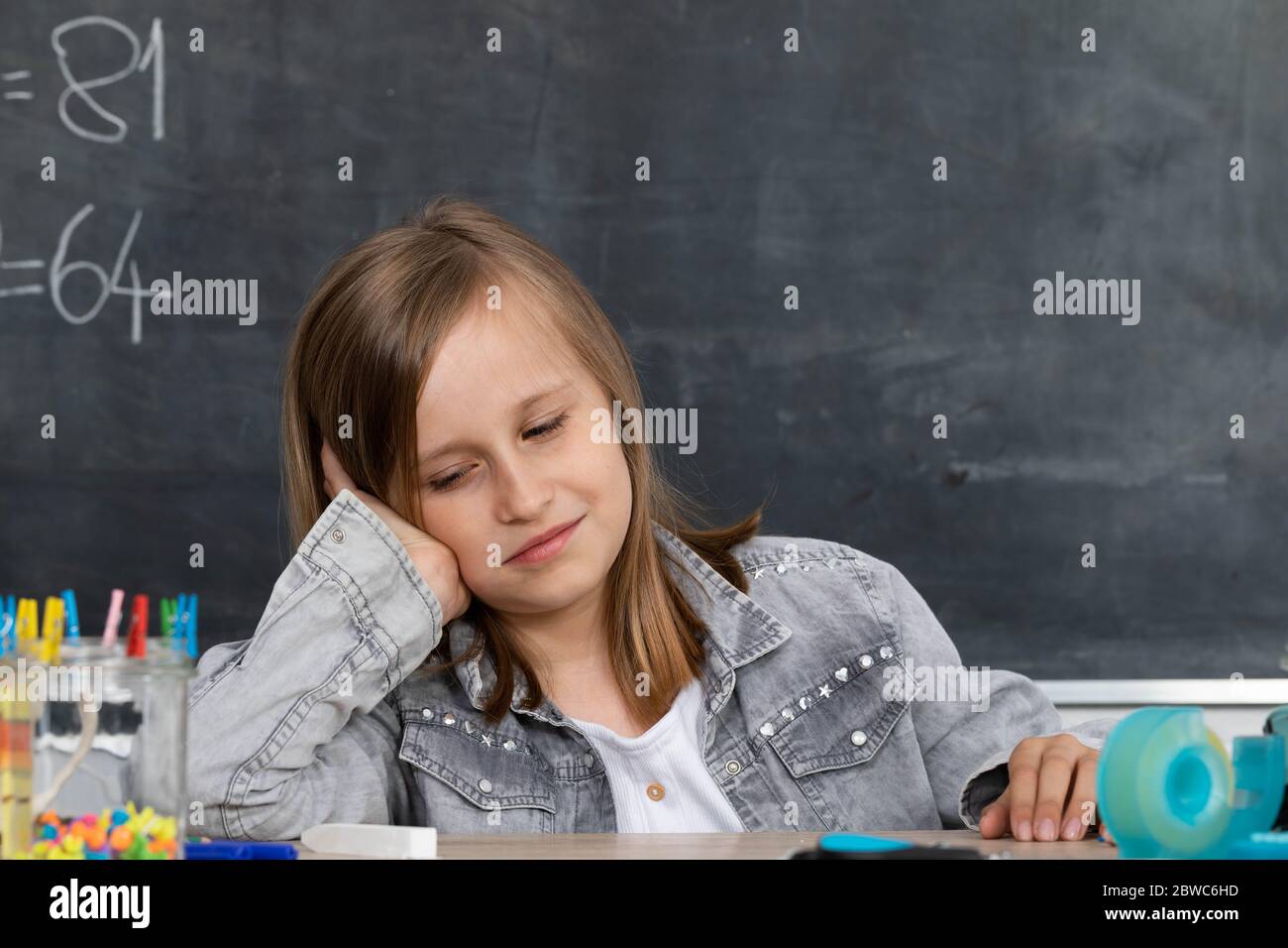 A difficult task at school. The schoolgirl is thinking about the right ...