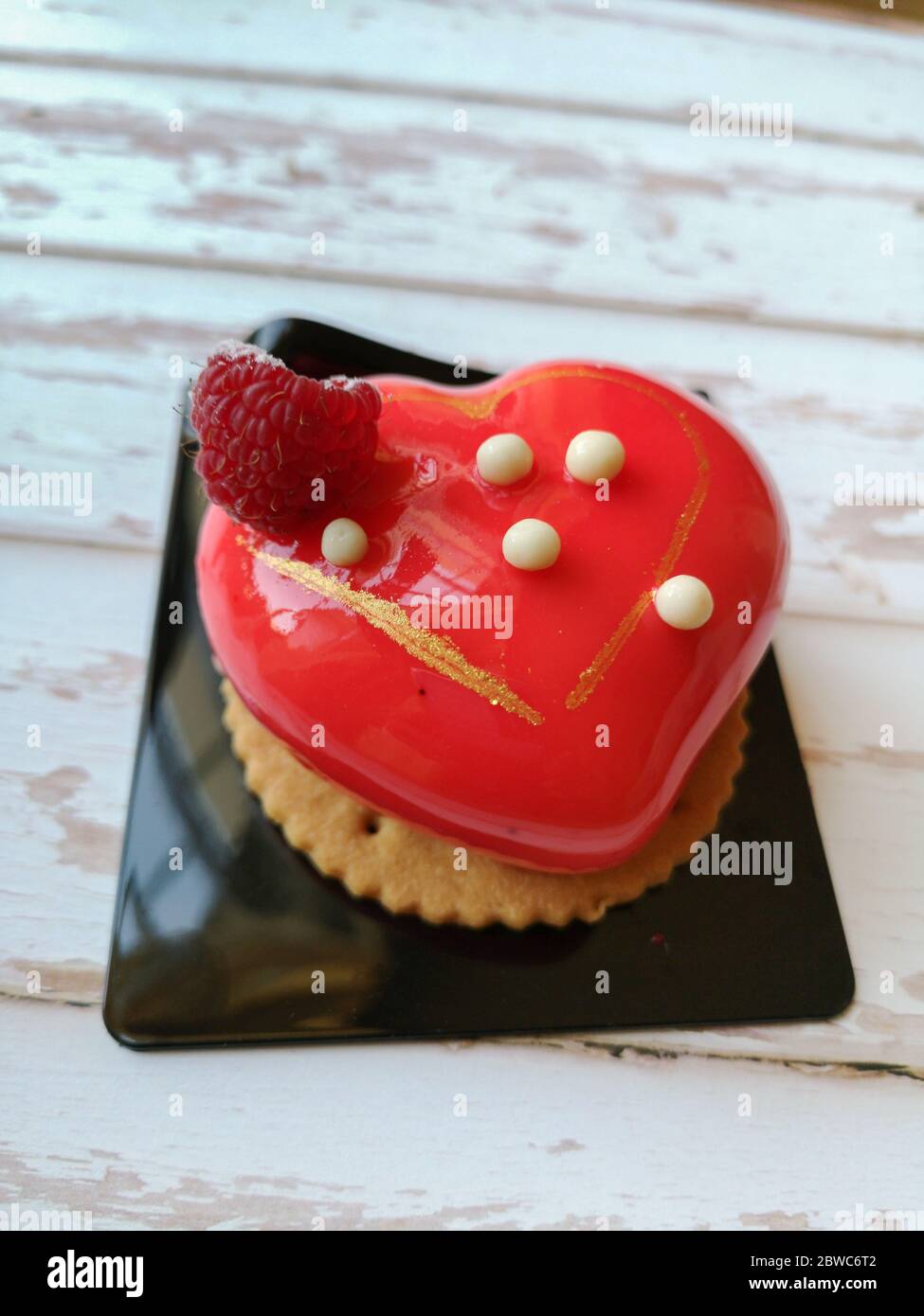 Red Heart-shaped Pastry with Biscuit and Raspberry Stock Photo - Alamy