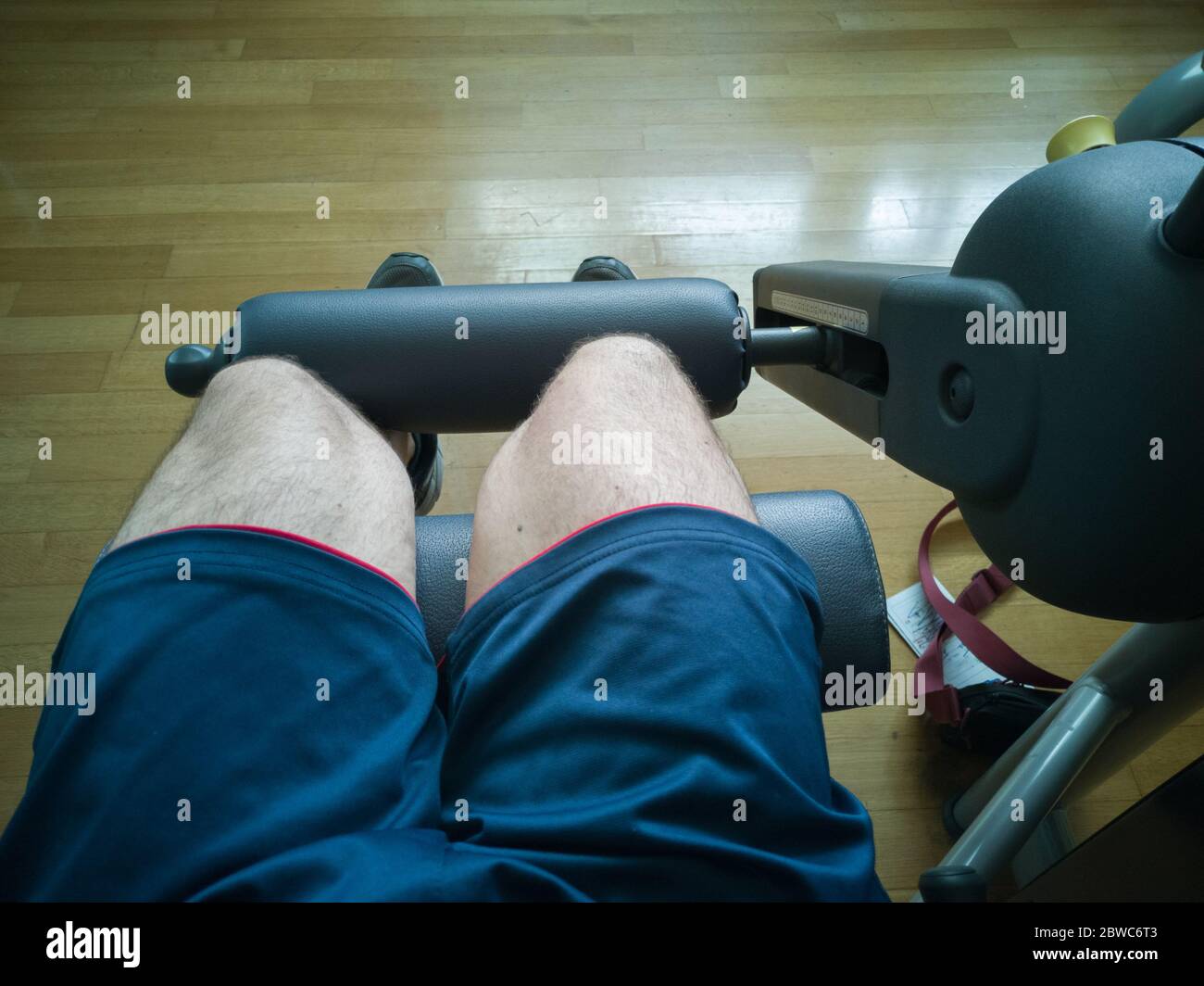 Doing Exercises at Gym: Leg Extensions Workout on Fitness Machine ...