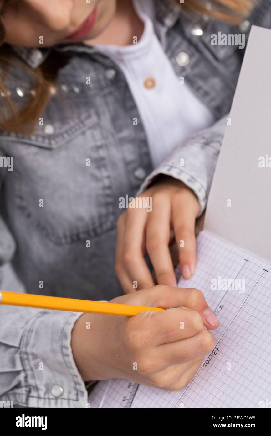 The student uses a ruler and pencil to draw lines that are the solution ...