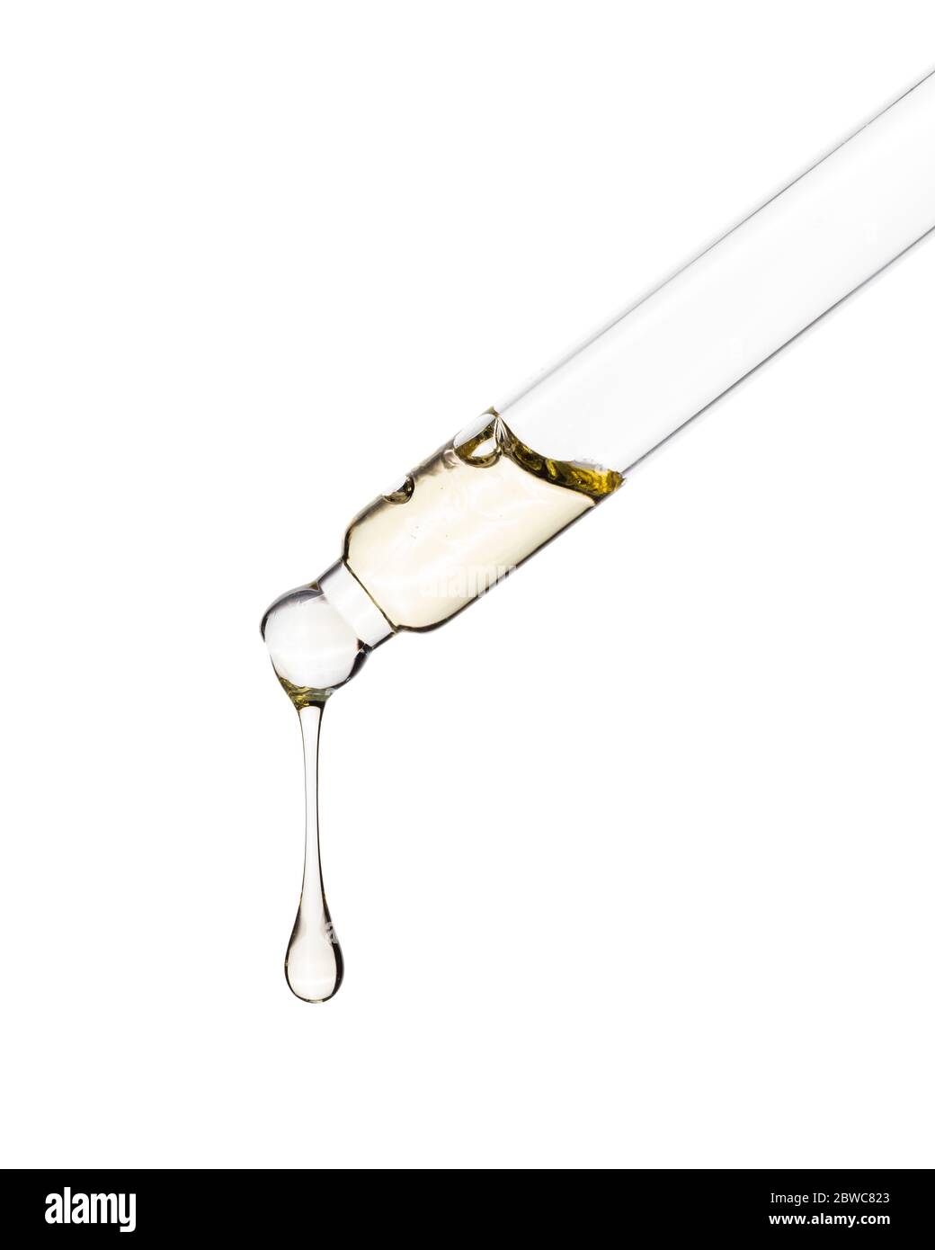 Cosmetic dropper with yellow oil. Glass dropper isolated on a white ...