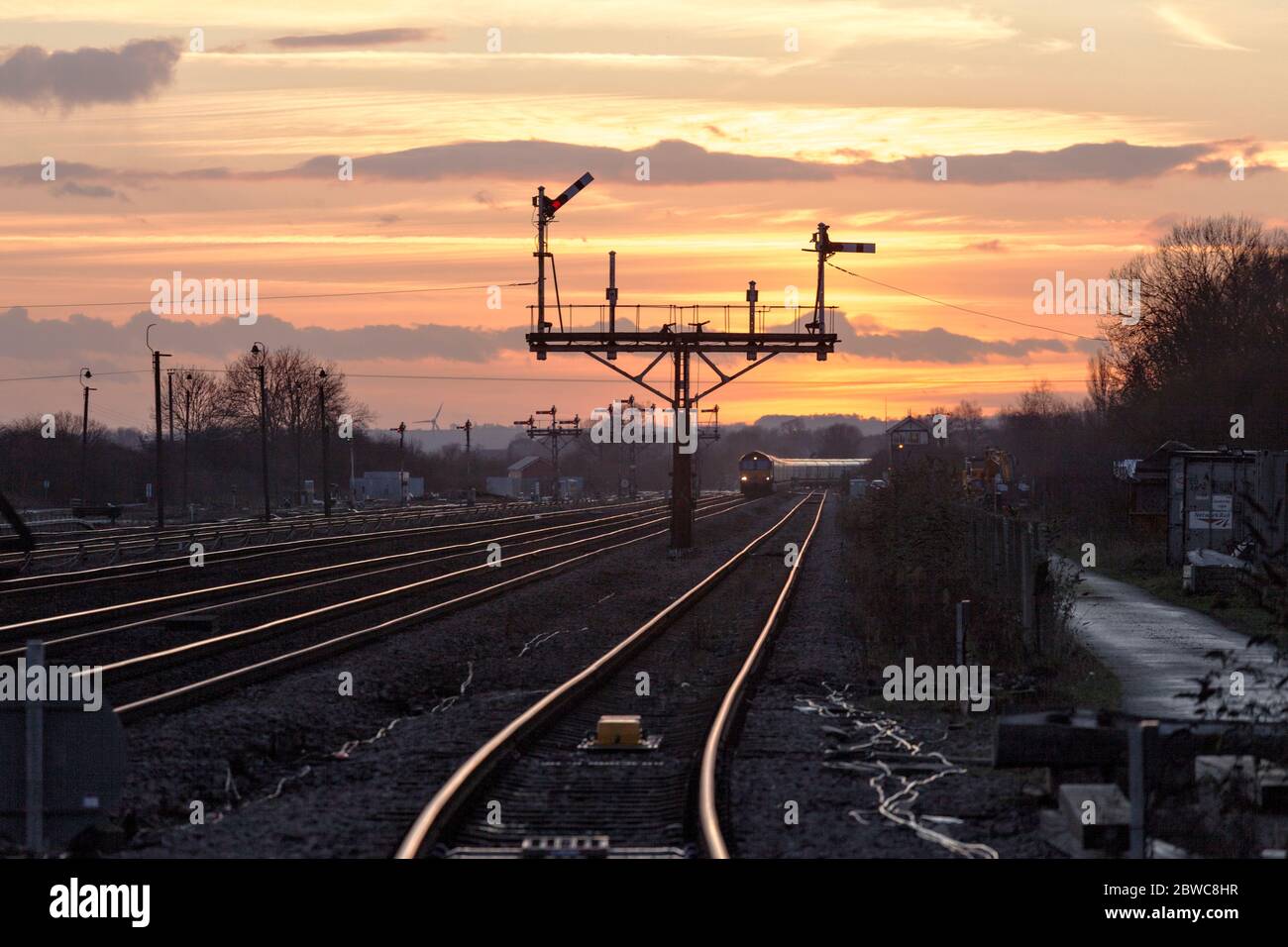 DB Cargo Rail UK class 66 locomotive hauling a freight train passing ...