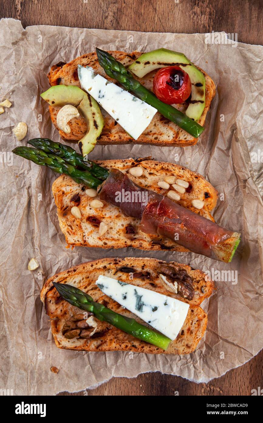 Homemade toasted bread served with green asparagus wrapped in bacon ...