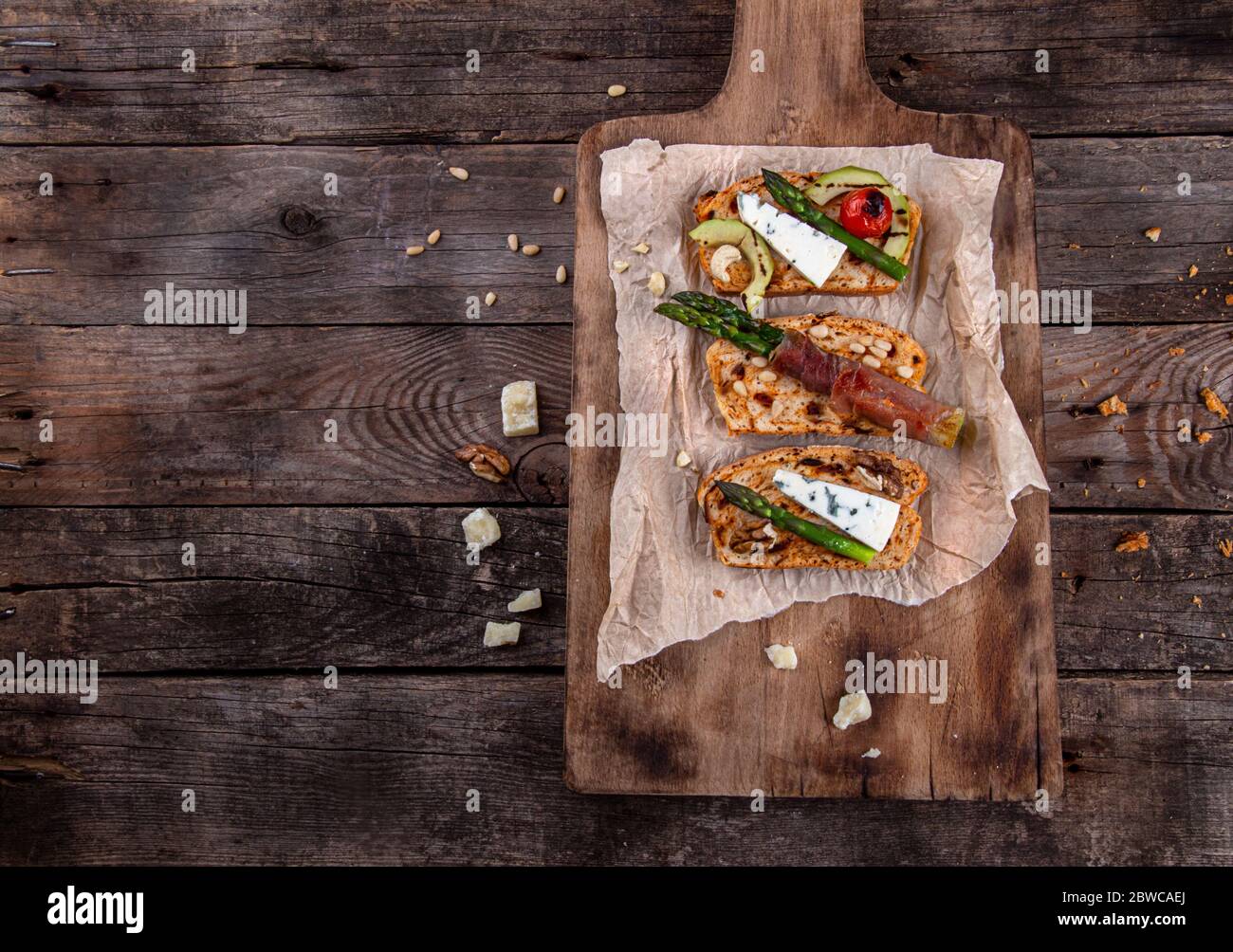 Homemade toasted bread served with green asparagus wrapped in bacon ...