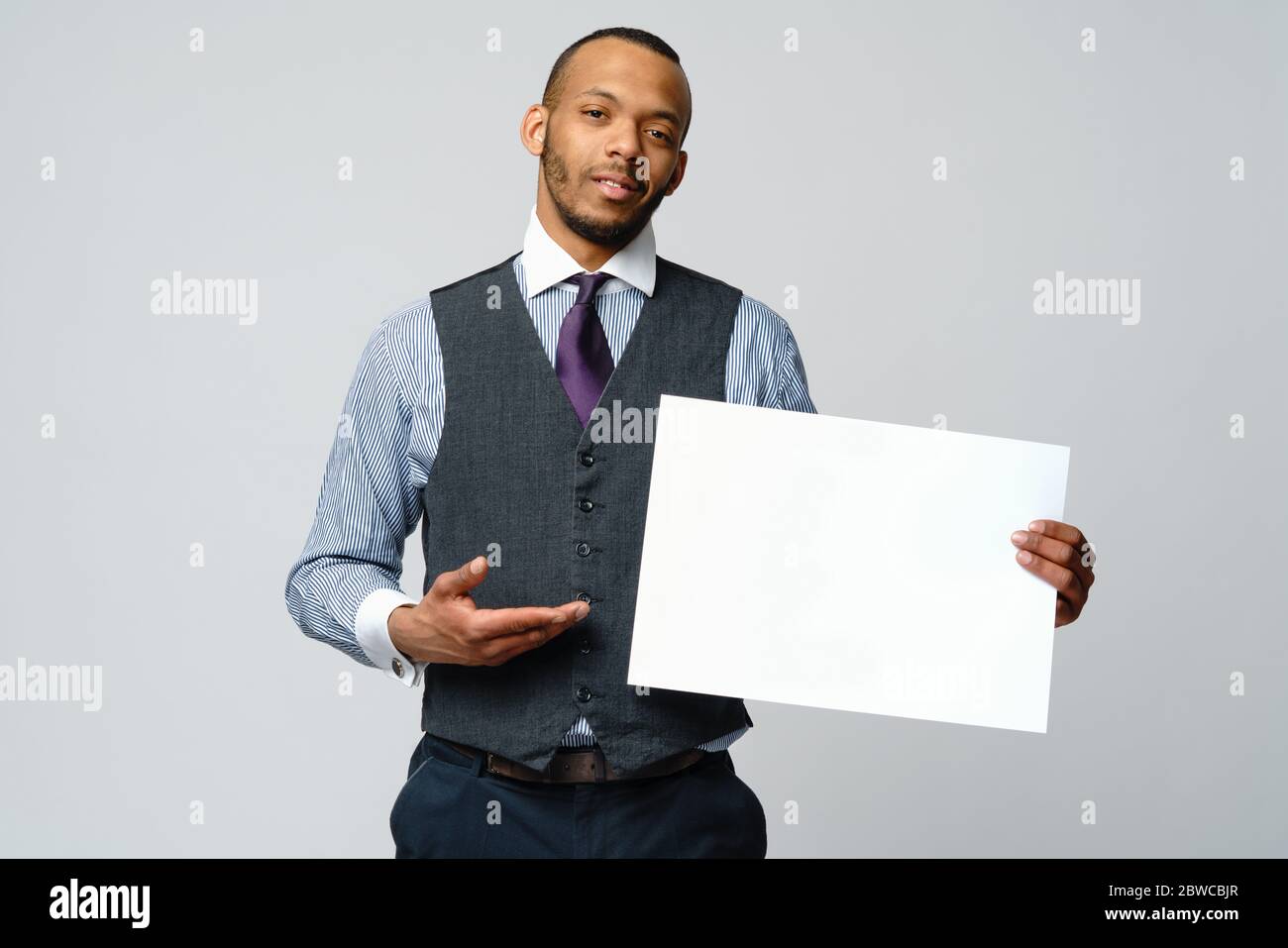 professional african-american business man - presenting holding blank ...