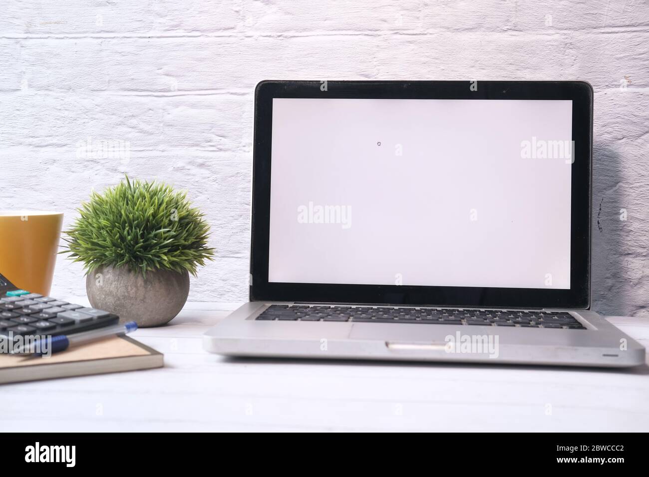 laptop with white screen on office table Stock Photo - Alamy