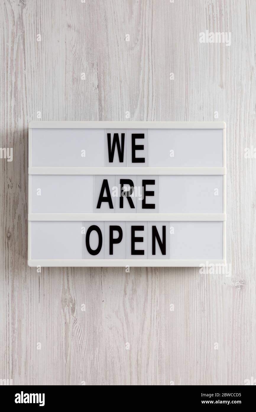 'We are open' text on a modern board, top view. Flat lay, overhead ...