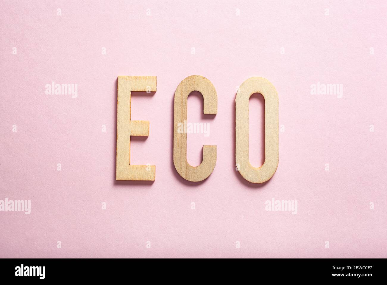 eco word text wooden letters on pink background Stock Photo - Alamy