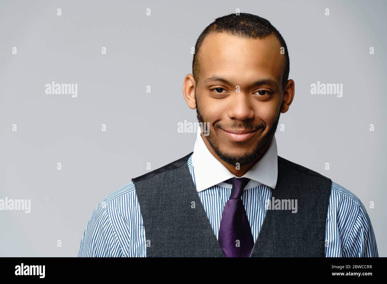 African-American man face portrait over grey background Stock Photo - Alamy