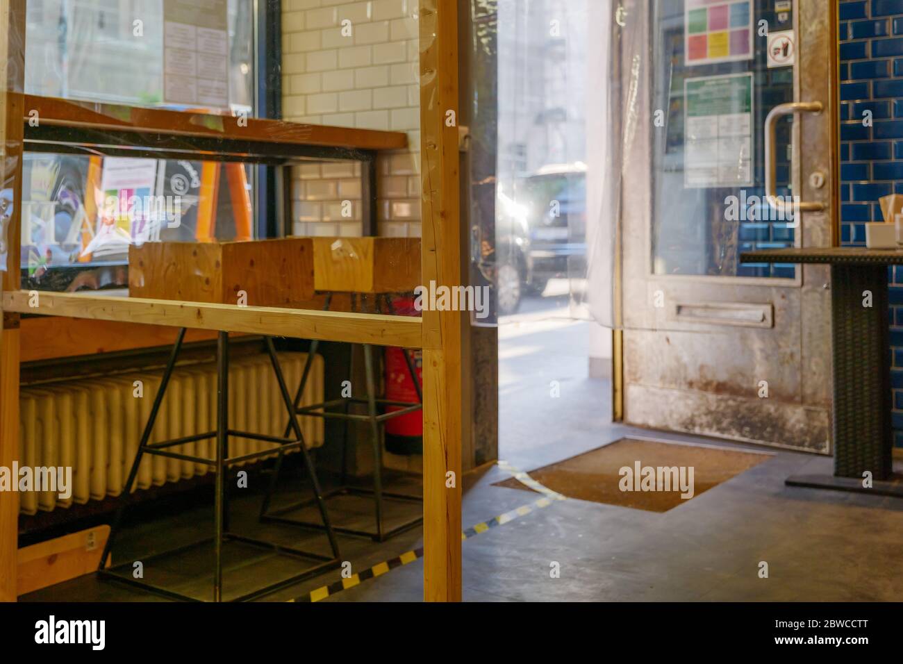 Temporary transparent plastic partition set up on wooden frame to ...