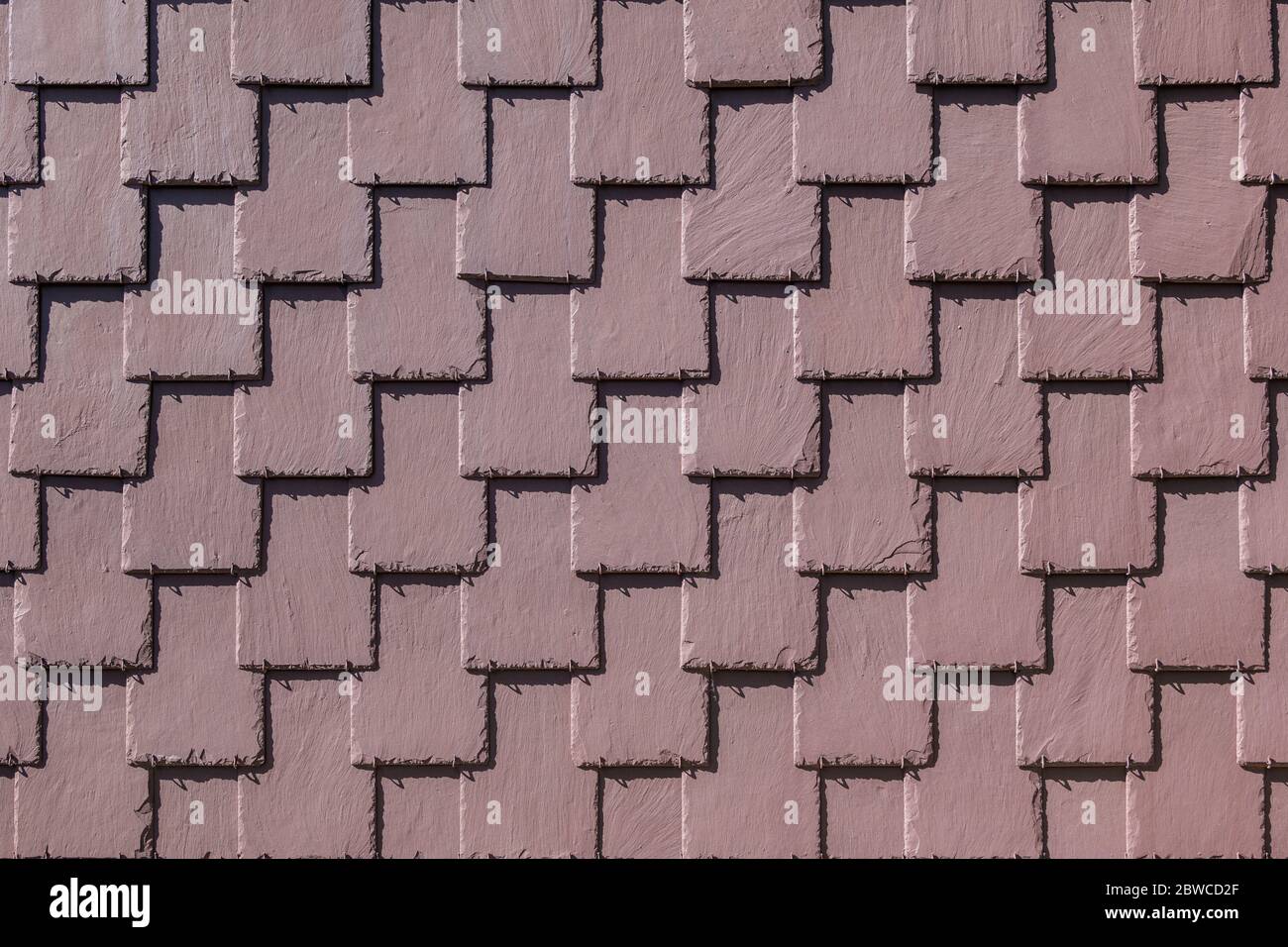 Red rectangular slate shingle tiles texture on roof, wall and facade ...