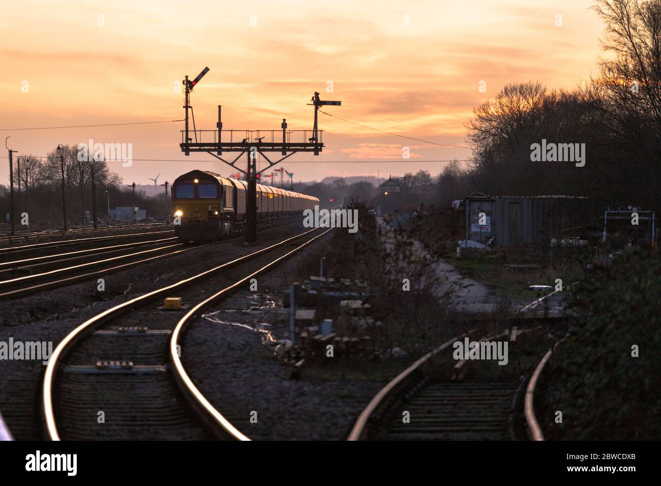 DB Cargo Rail UK class 66 locomotive hauling a freight train passing ...