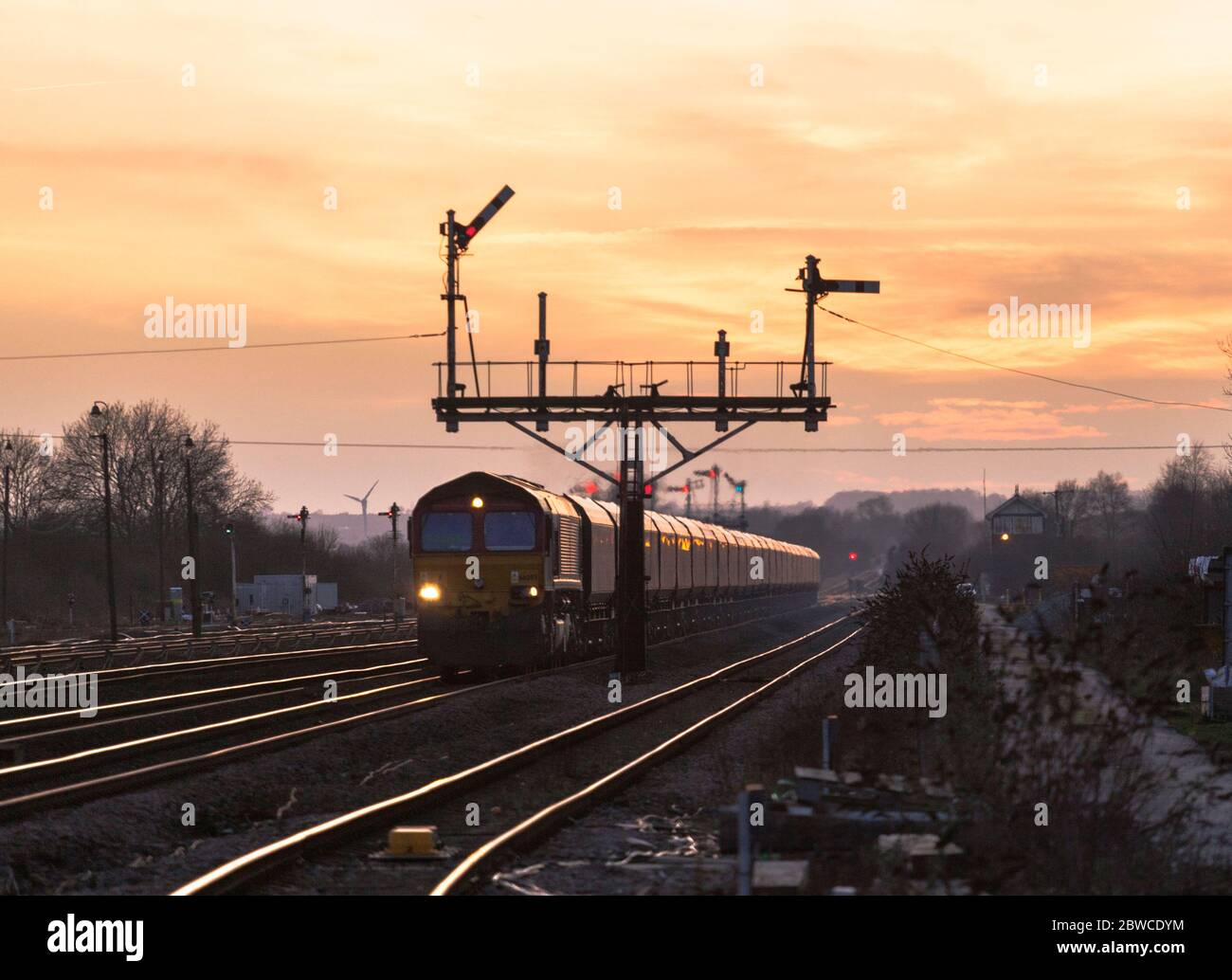 DB Cargo Rail UK class 66 locomotive hauling a freight train passing ...