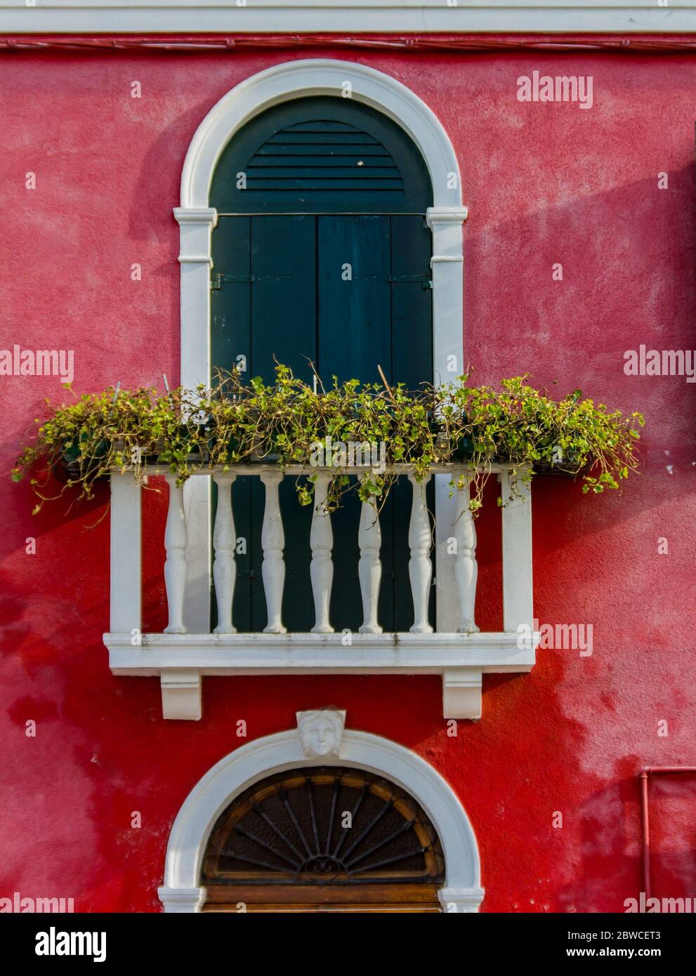 Old traditional window on the colorful facade of building in Burano ...