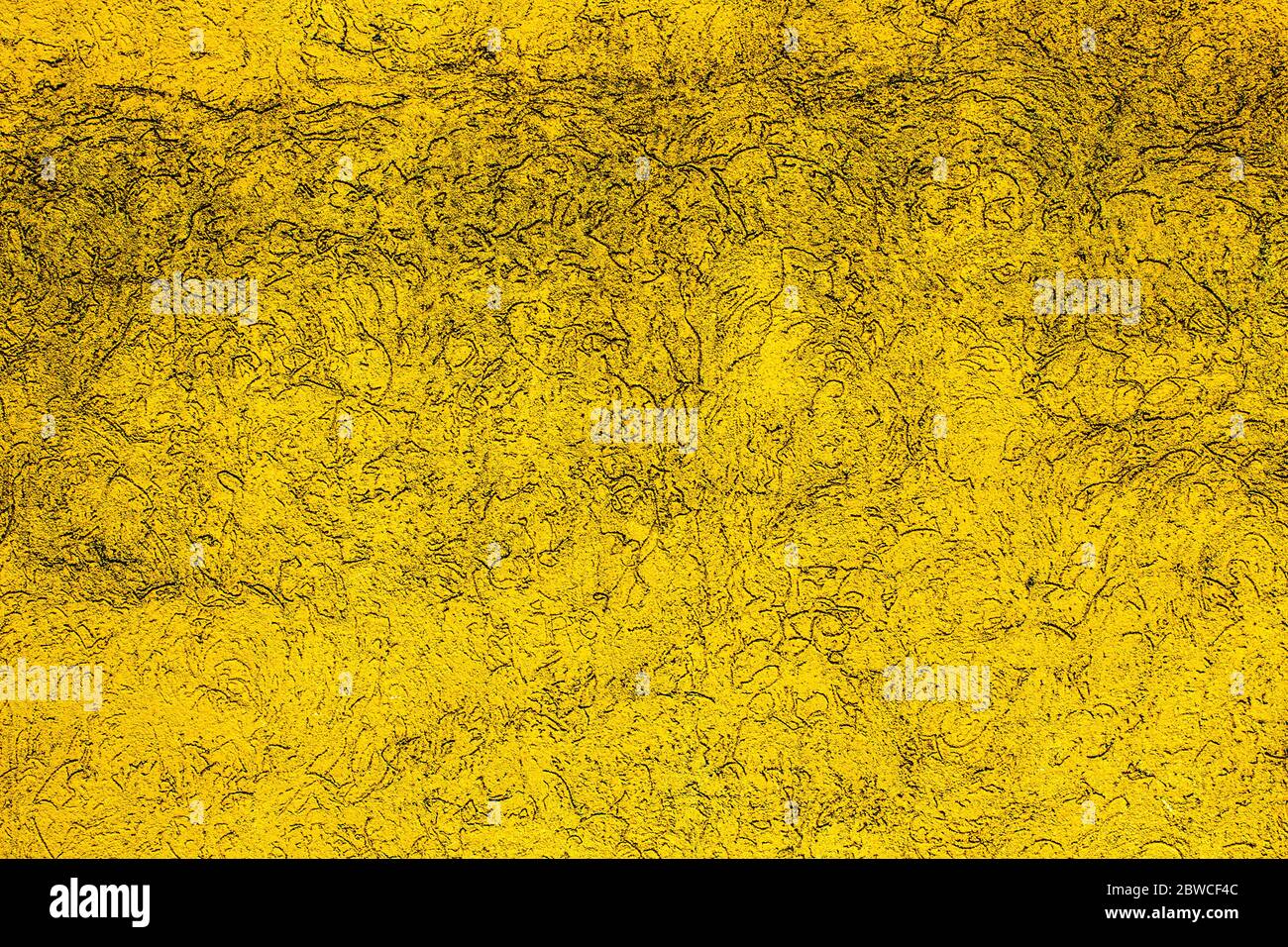 Yellow colored abstract wall background with textures of different ...