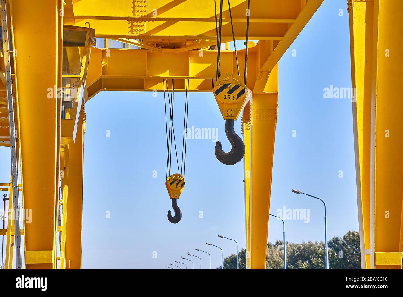 Crane with hooks hanging Stock Photo - Alamy