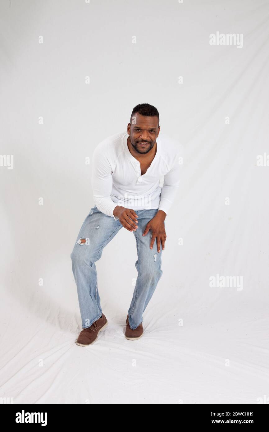 Pensive Black man kneeling Stock Photo - Alamy