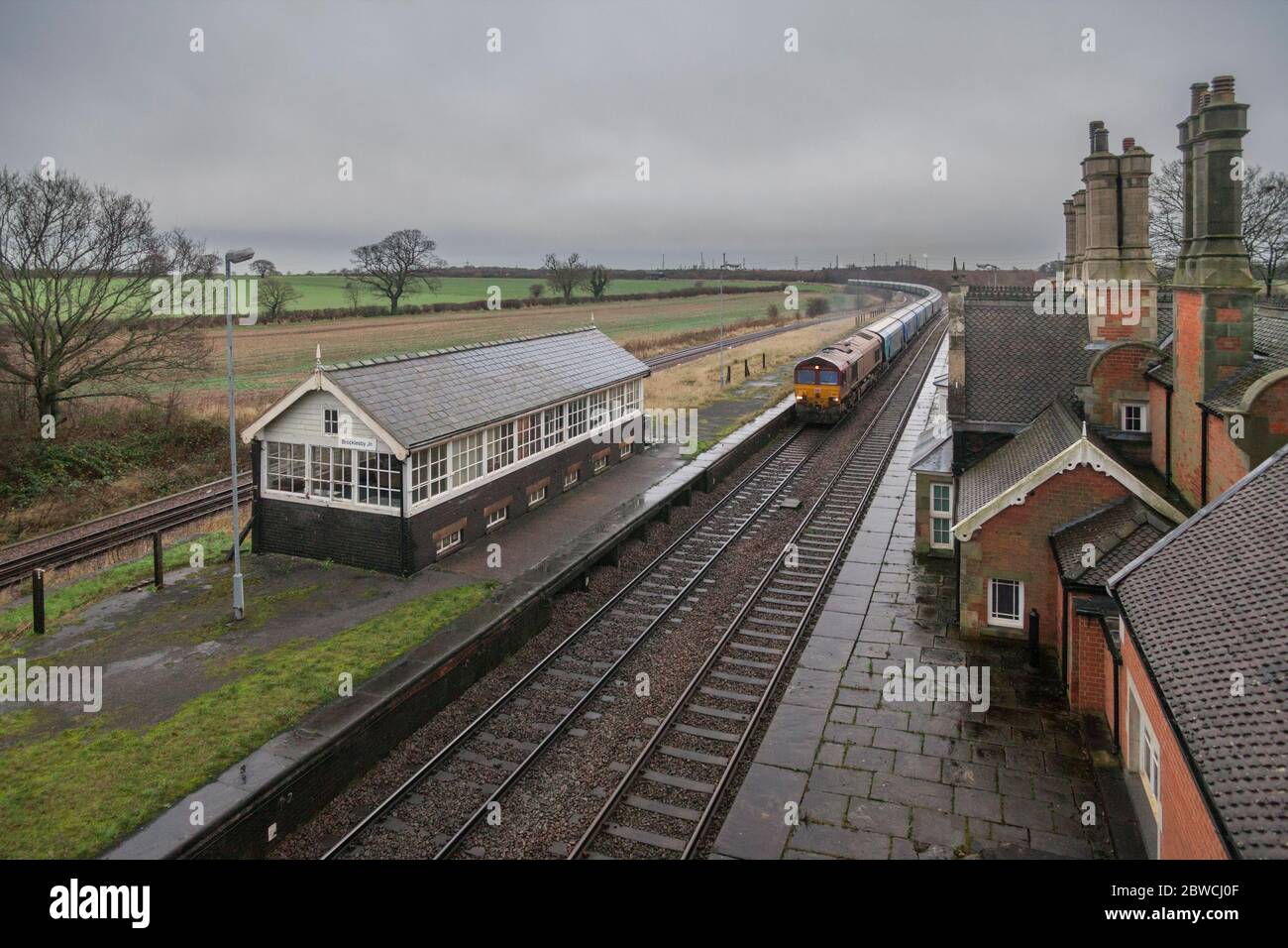 DB cargo class 66 locomotive 66124 passing the signal box on the closed ...