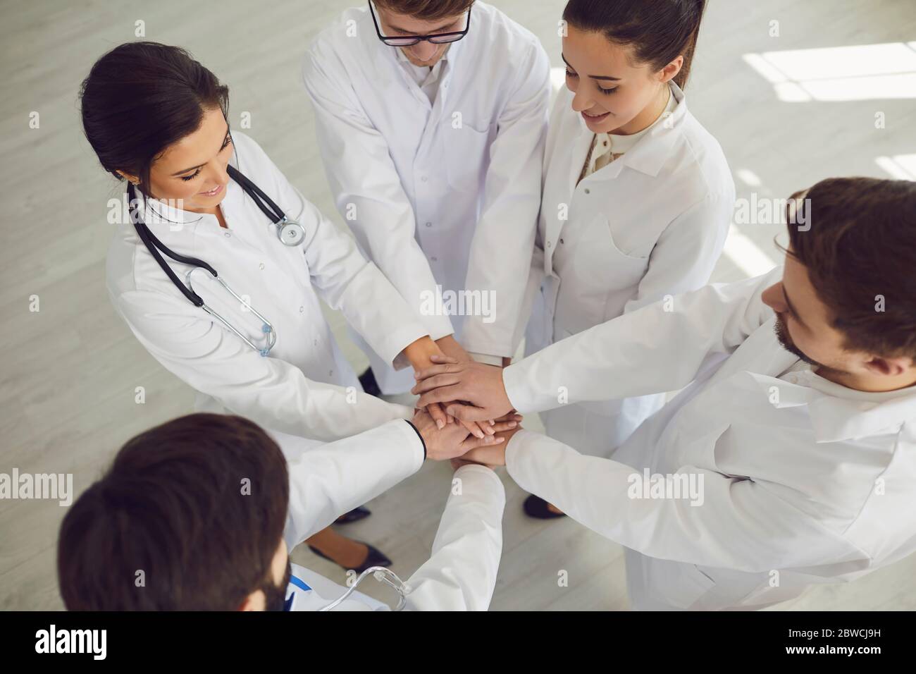 Group of doctors joined hands together. Medicine healthcare clinic ...