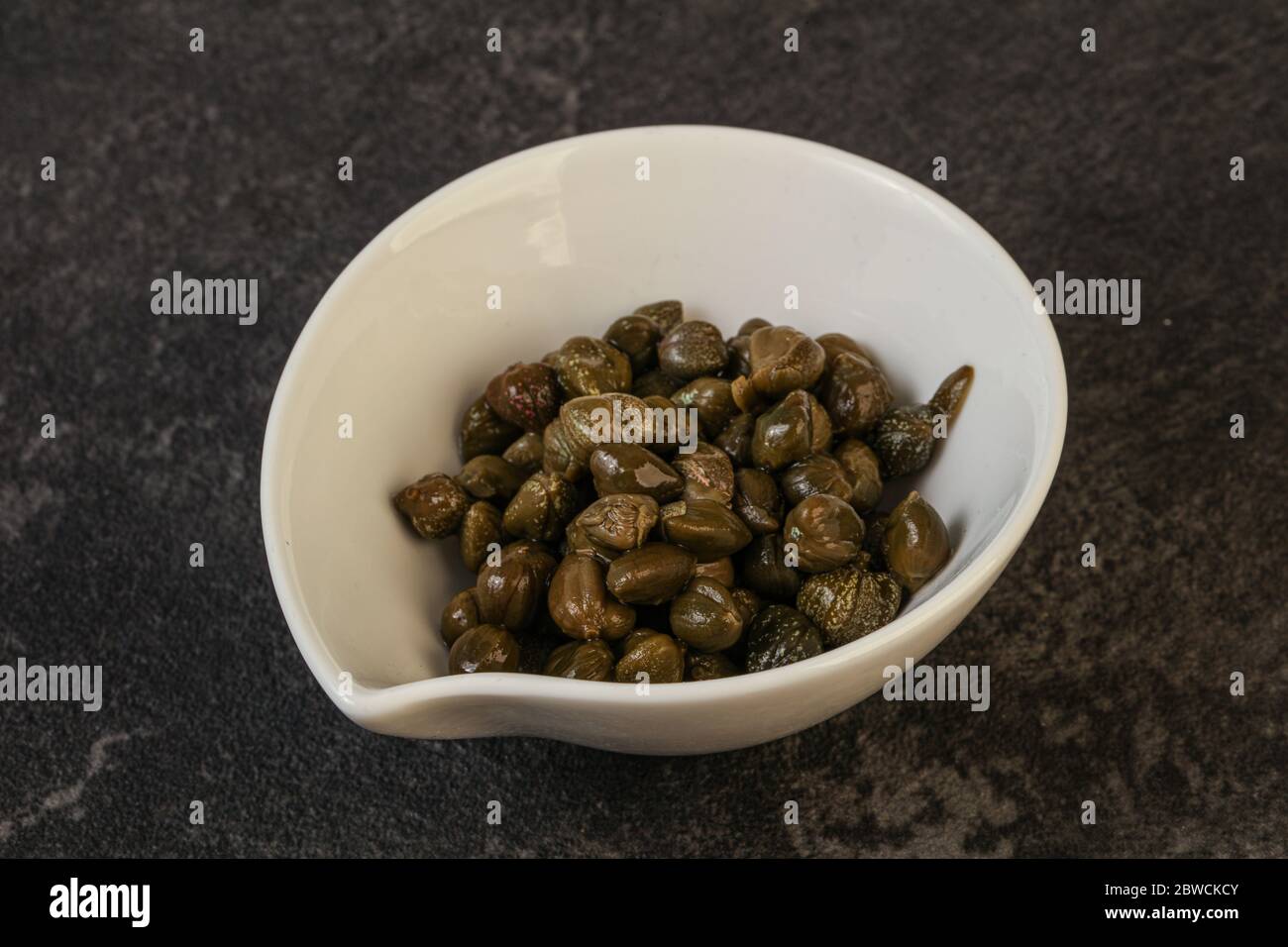 Tasty marinated capers in the bowl Stock Photo - Alamy
