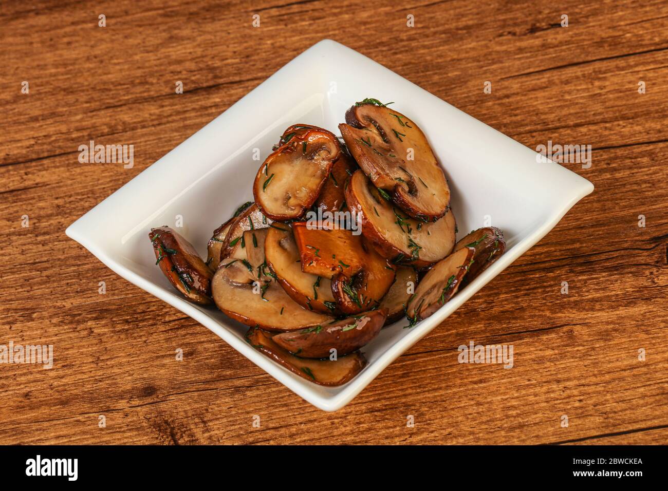 Roasted champignon with herbs and spices in the bowl Stock Photo - Alamy