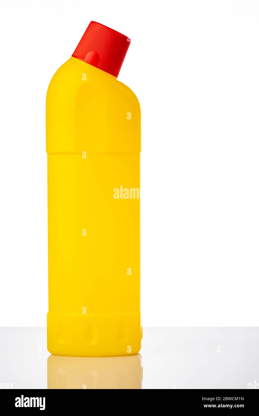 Yellow plastic bottle with detergent and cleaning supplies with ...