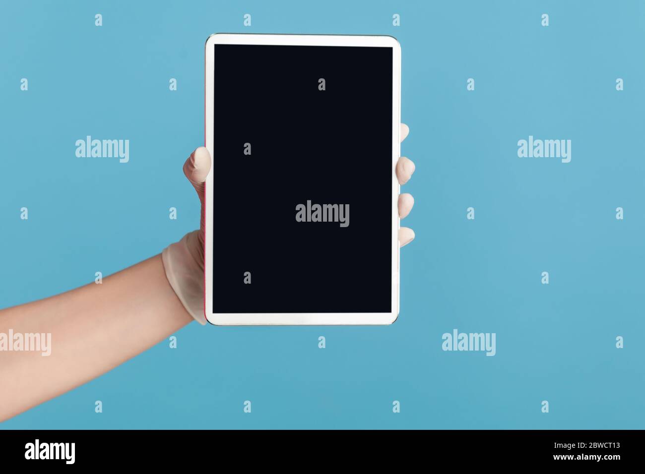 Profile side view closeup of human hand in white surgical gloves ...