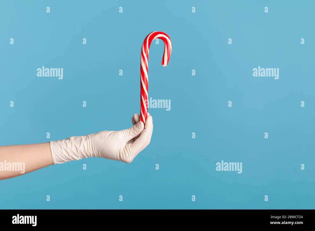 Profile side view closeup of human hand in white surgical gloves ...