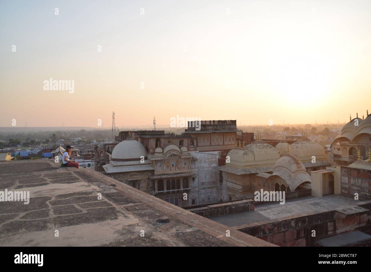 Tourist watching the beautiful sunset from the rooftop in India Stock ...