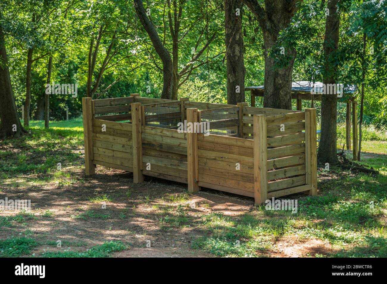 Three system compost bins together wooden with slats to add or take off ...