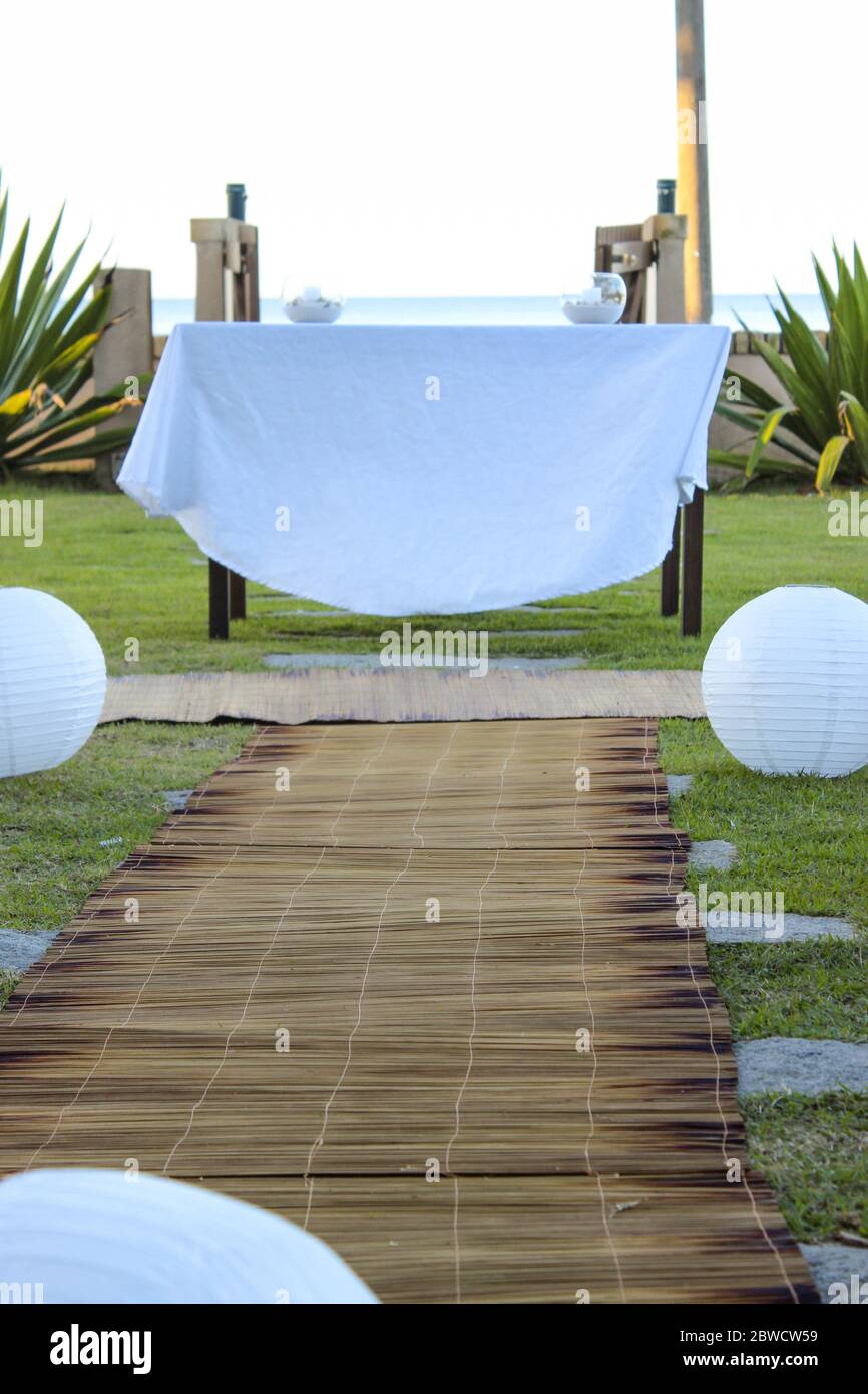 In the center of the image we have a table with two centerpieces that ...