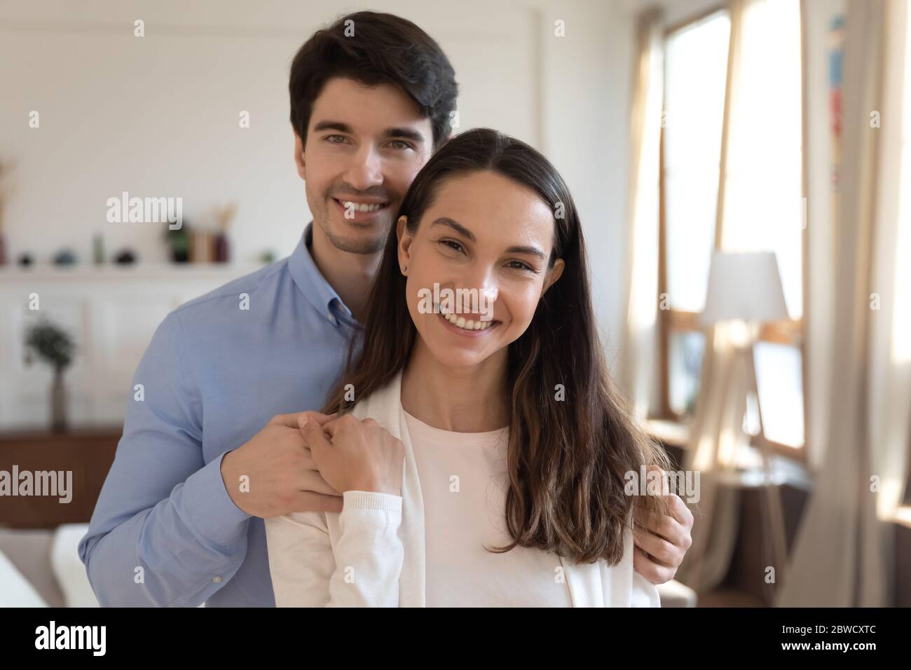 Portrait of happy couple hug pose in new home Stock Photo - Alamy