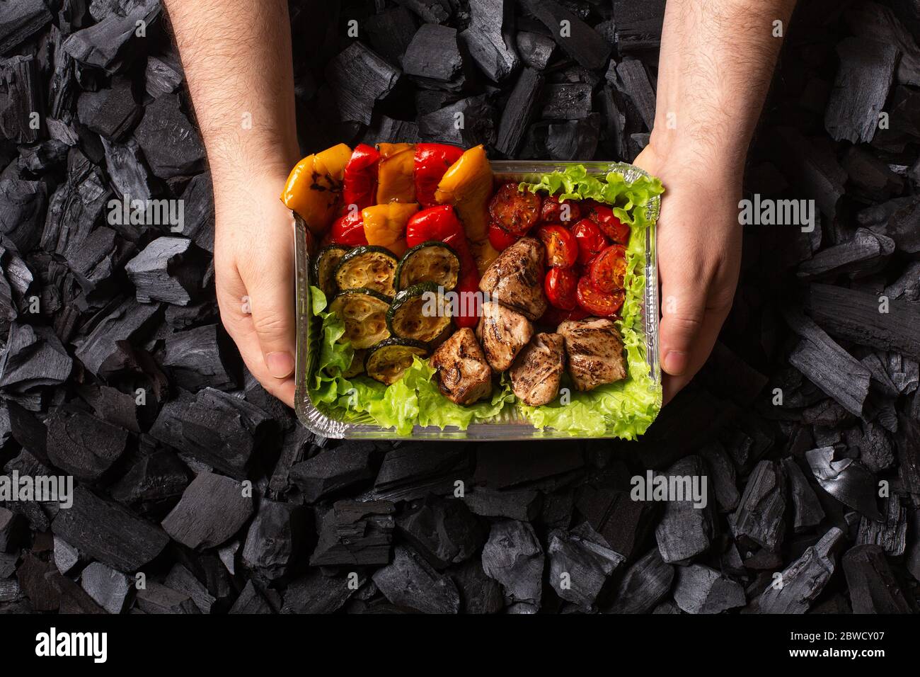 Ready shish kebab. Portion of grilled meat and vegetables in a ...