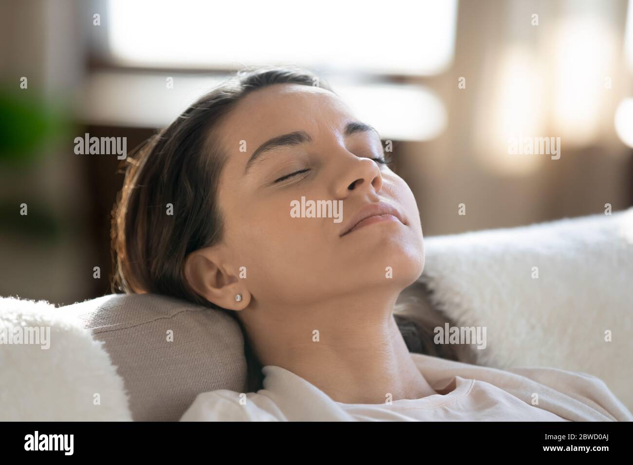 Calm young woman sleeping relaxing on sofa Stock Photo - Alamy