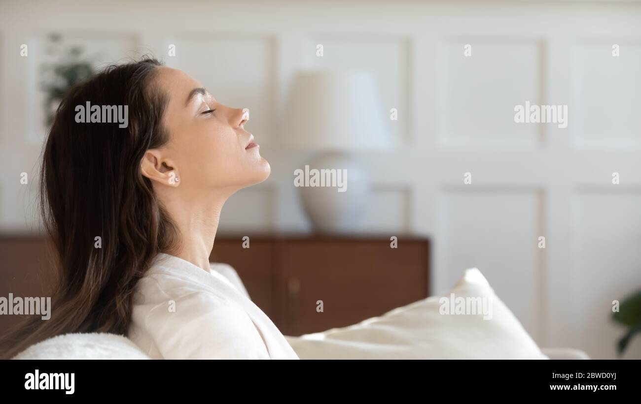 Profile view of woman relax on couch with eyes closed Stock Photo - Alamy