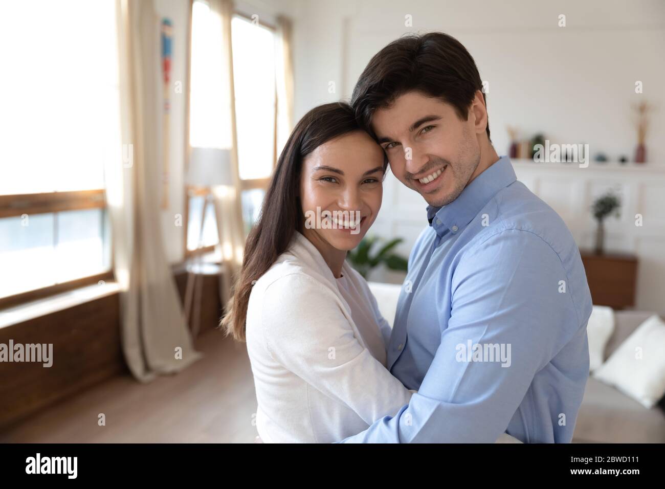 Portrait of happy young couple hug and cuddle Stock Photo - Alamy