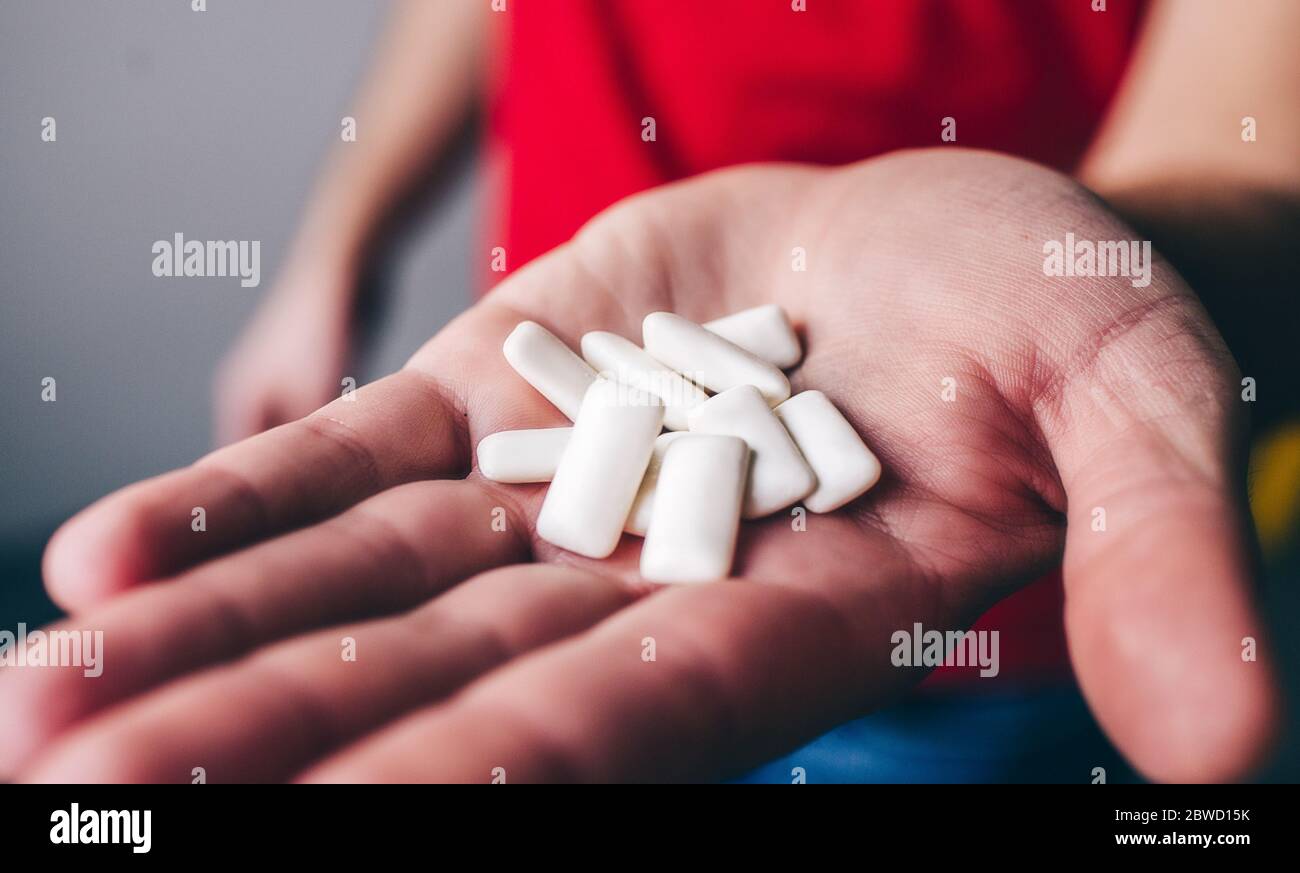 Man's hand holding mint chewing gum on hand and show it on camera ...