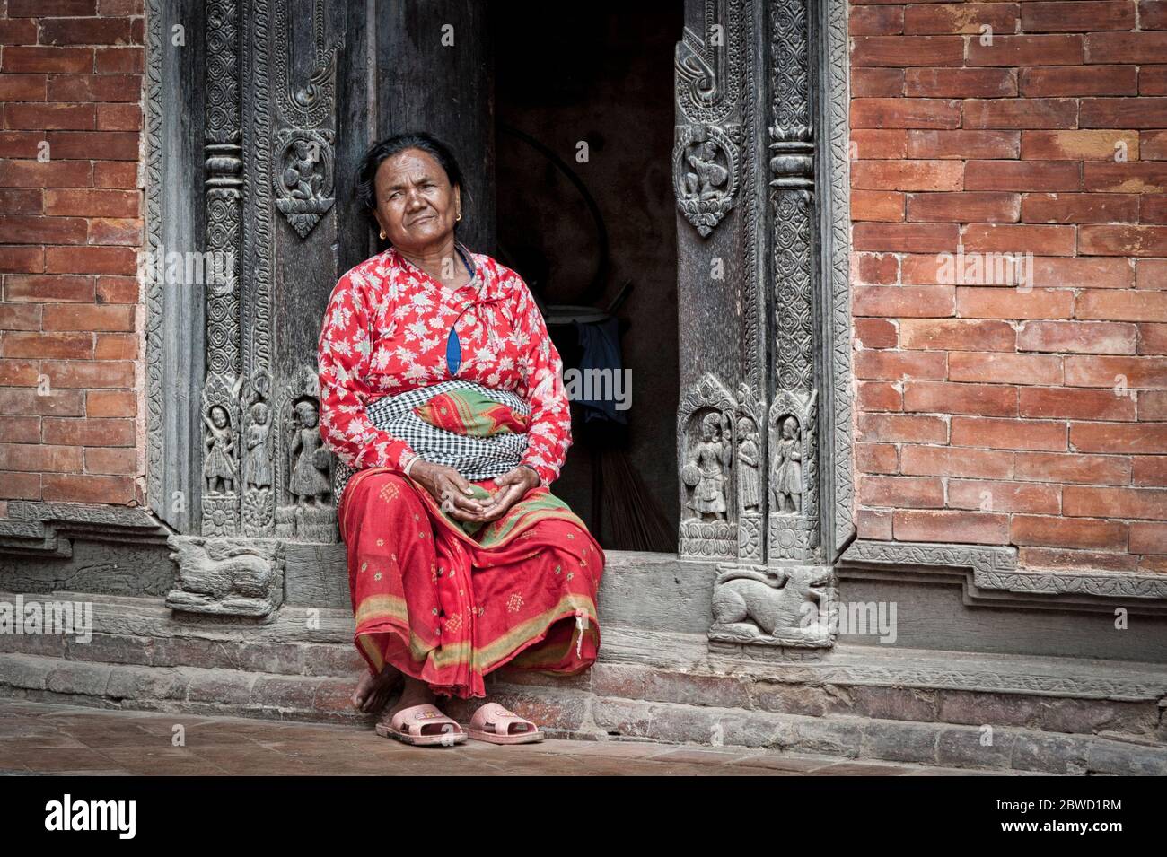Unidentified Newari elderly woman sit in the courtyard of Keshav ...