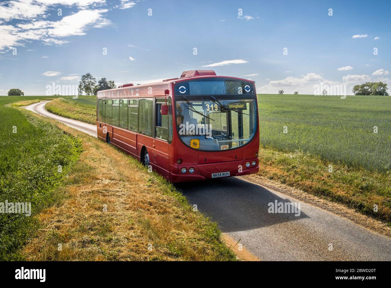 Rural bus service bus on a narrow country road in Suffolk, England, UK ...