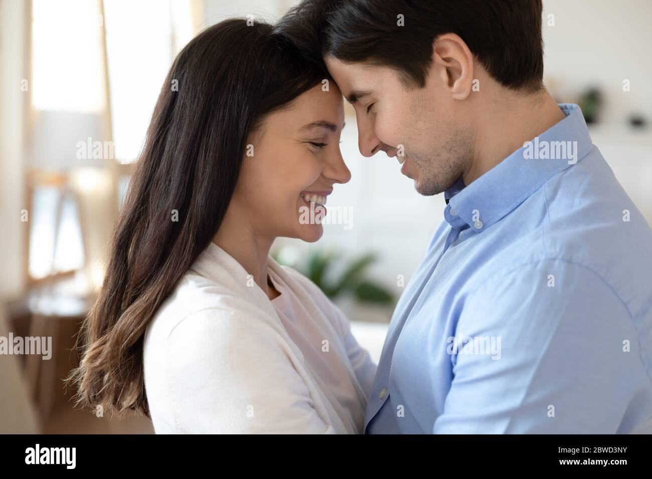 Loving young couple hug enjoy tender moment together Stock Photo - Alamy